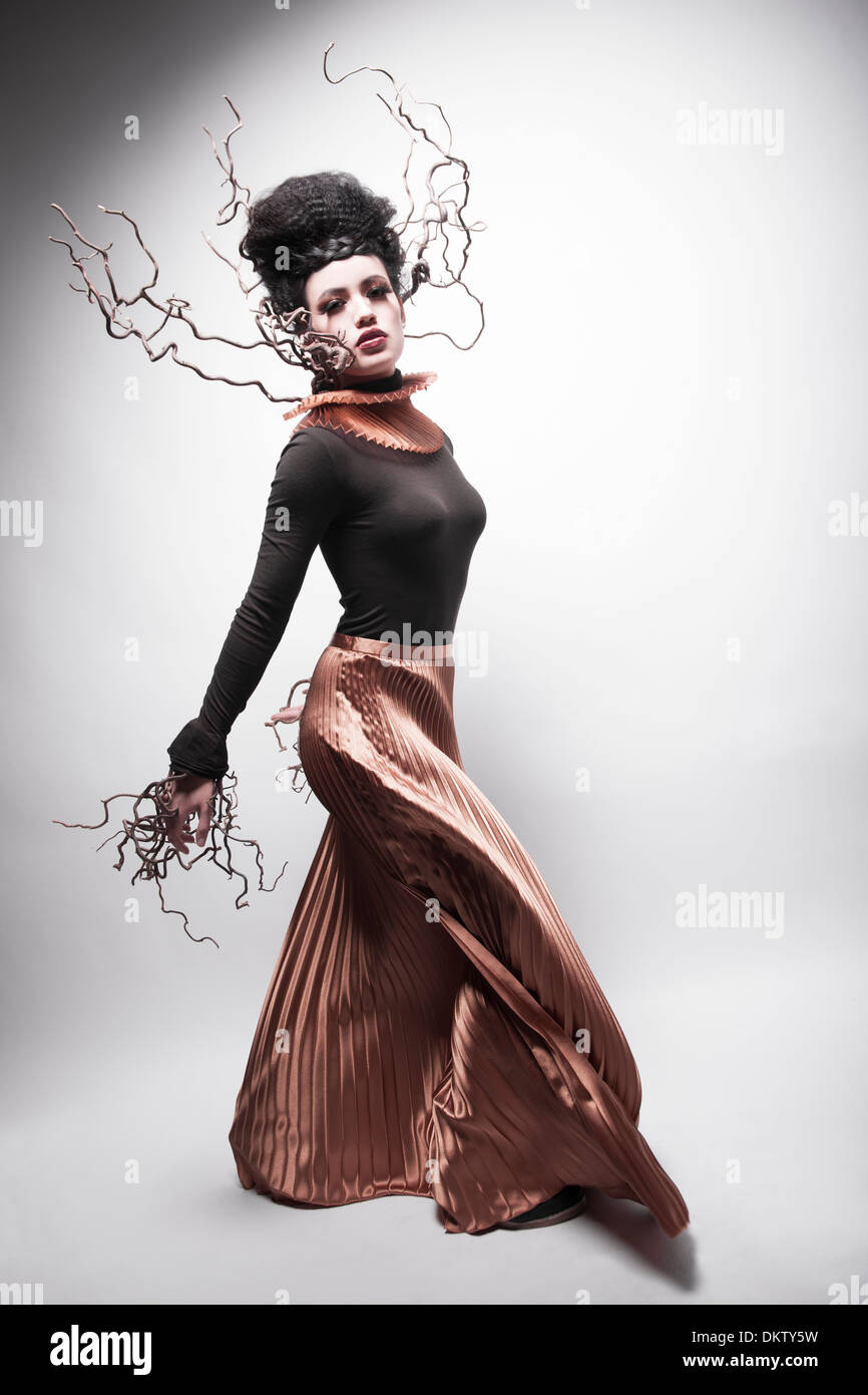 Portrait of a young woman wearing twigs Stock Photo - Alamy