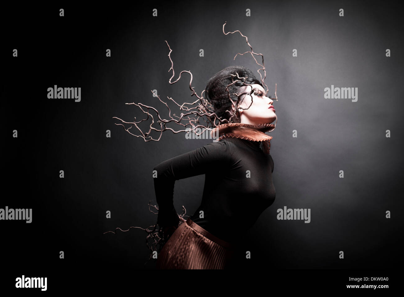 Portrait of a young woman wearing twigs Stock Photo - Alamy