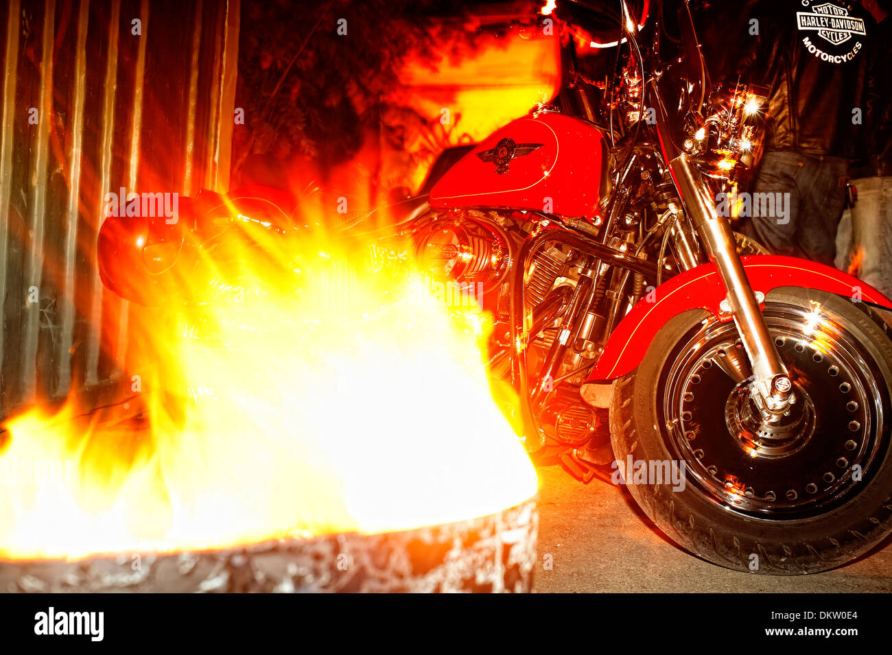 Motorcycles parked between barrels with fire in a street party Stock ...