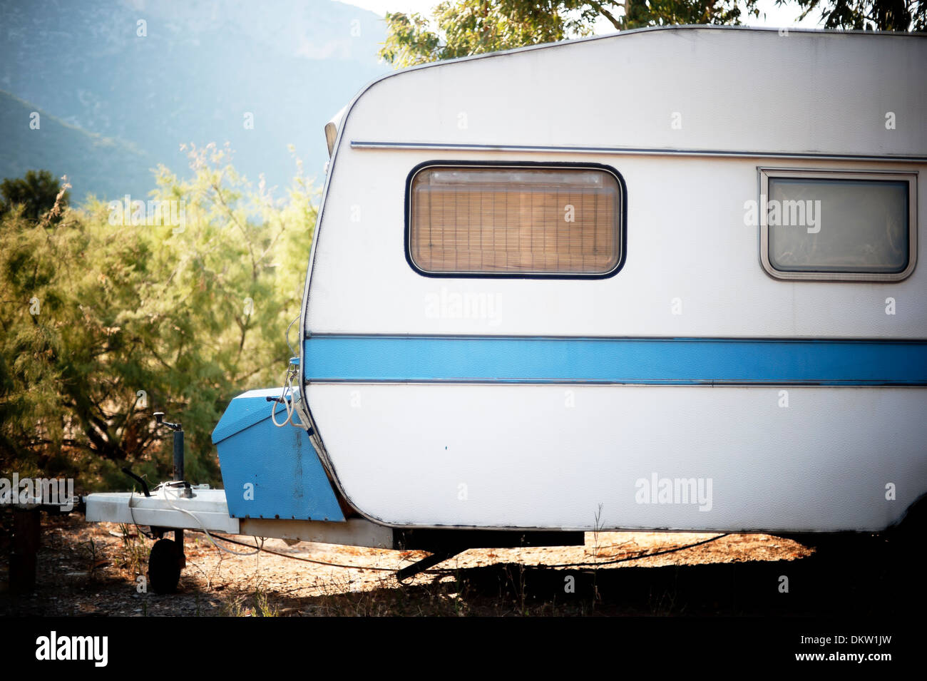 Old caravan parked in a campsite Stock Photo - Alamy