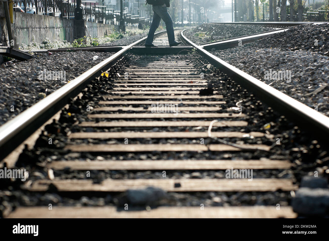 Man crossing railway tracks Stock Photo - Alamy