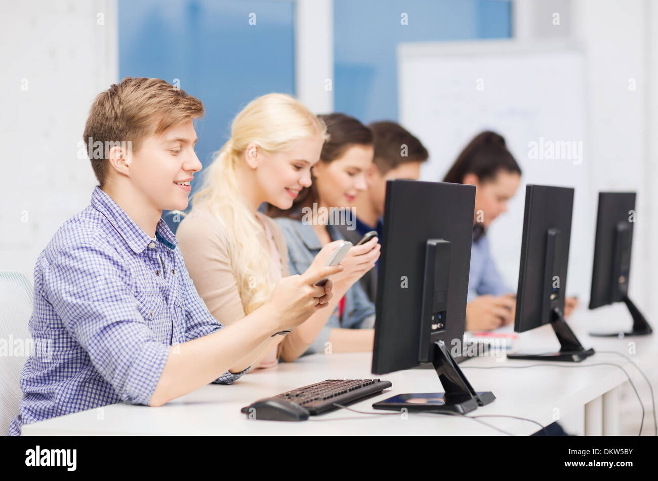 students with computer monitor and smartphones Stock Photo - Alamy