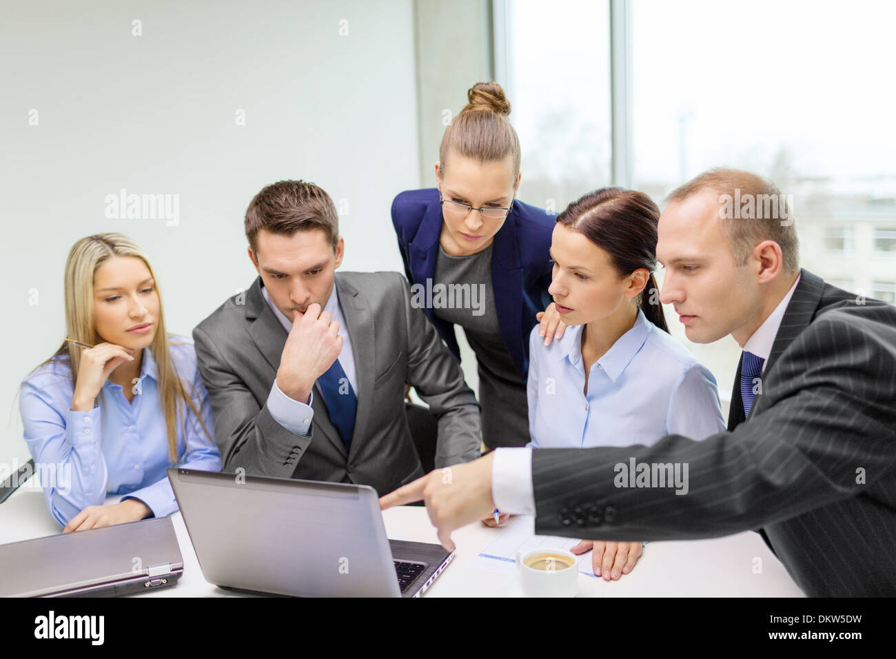 business team with laptop having discussion Stock Photo - Alamy