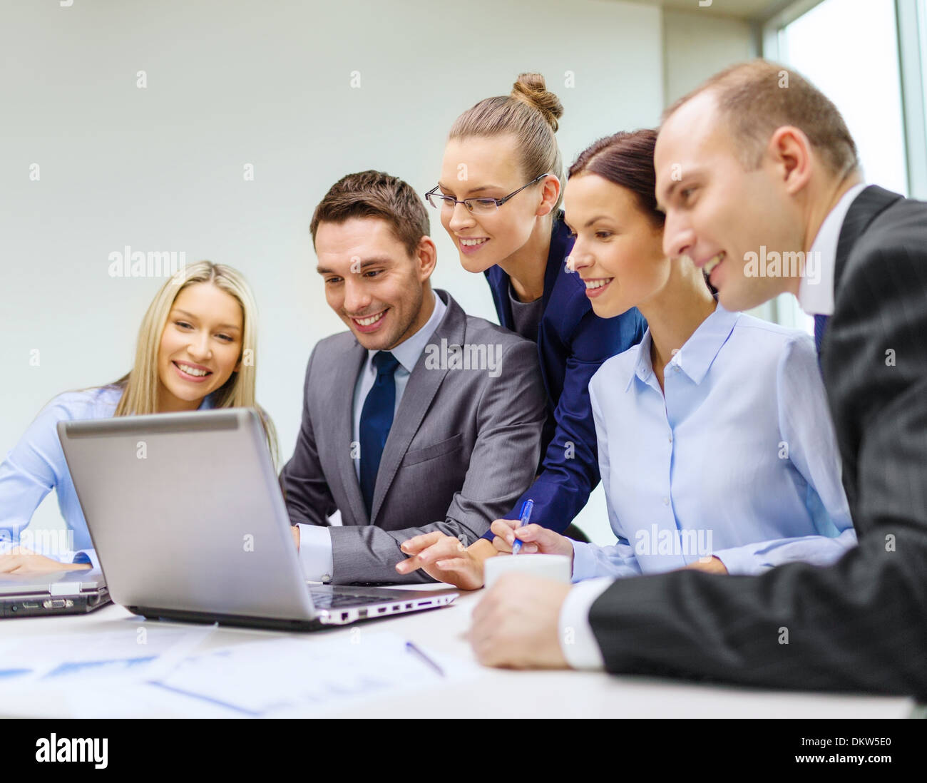 business team with laptop having discussion Stock Photo - Alamy