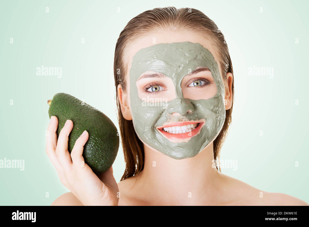 Beautiful woman with green avocado clay facial mask Stock Photo - Alamy