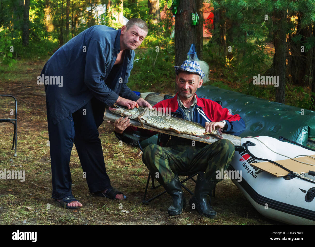 Rural summer lifestyle 2013 - 11. Fishermen show hooked fish Stock ...