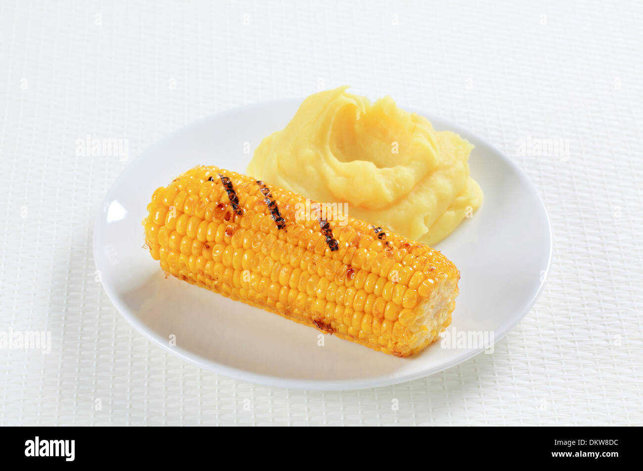 Dish of grilled sweet corn with mashed potato Stock Photo - Alamy