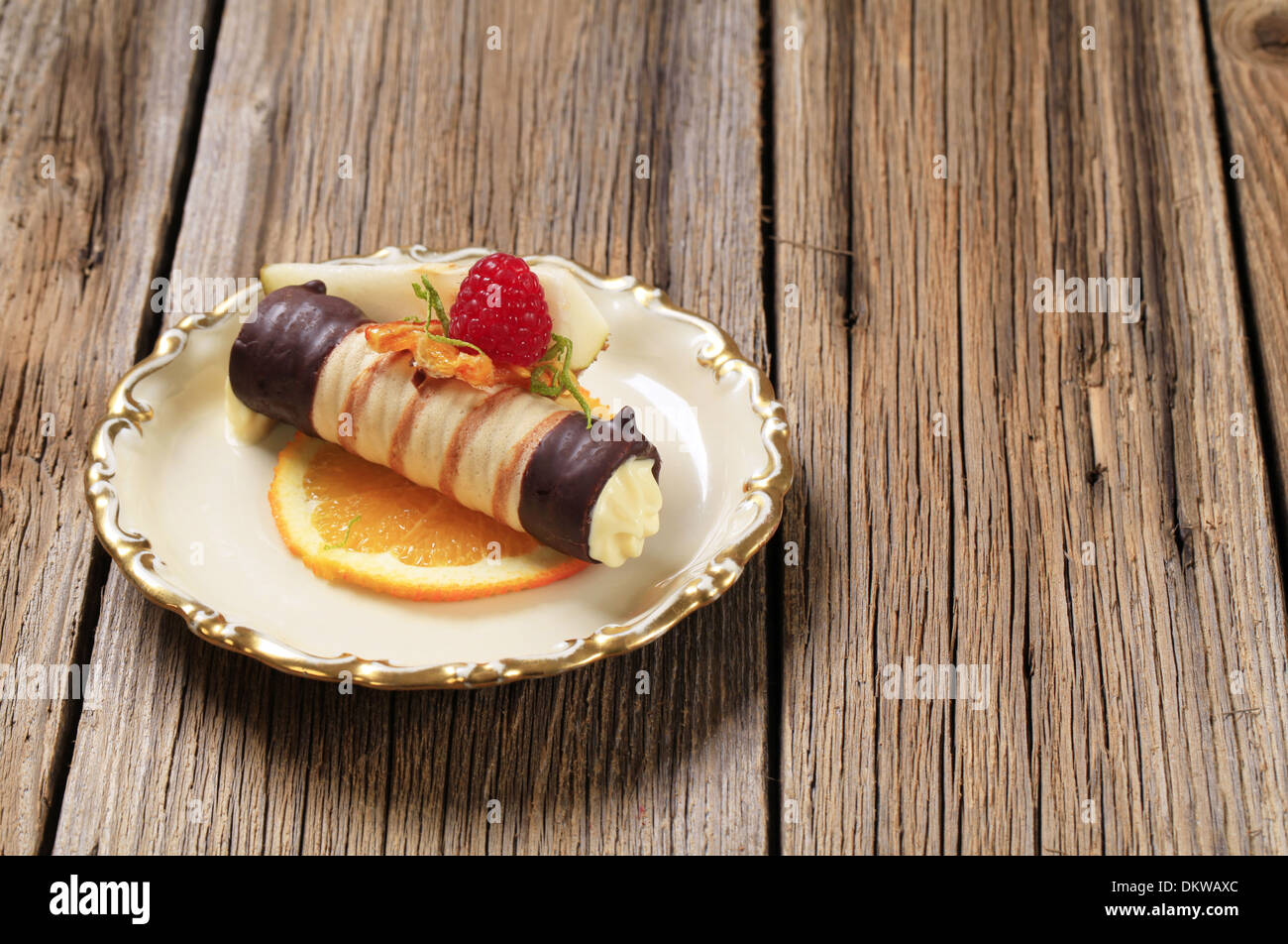 Cream filled wafer roll garnished with fresh fruit Stock Photo - Alamy
