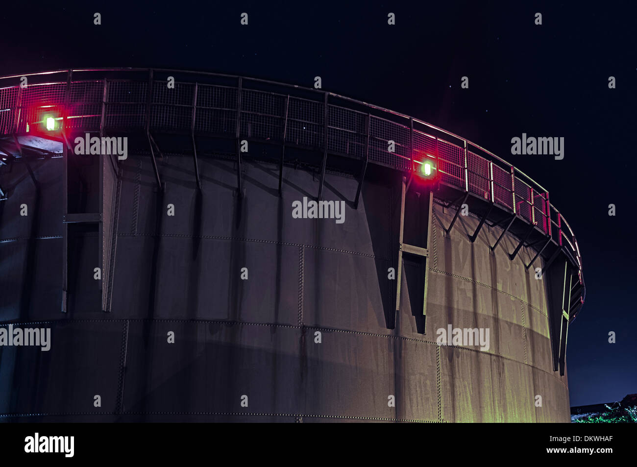 A gasometer at night, used in the storage and pressure regulation of ...