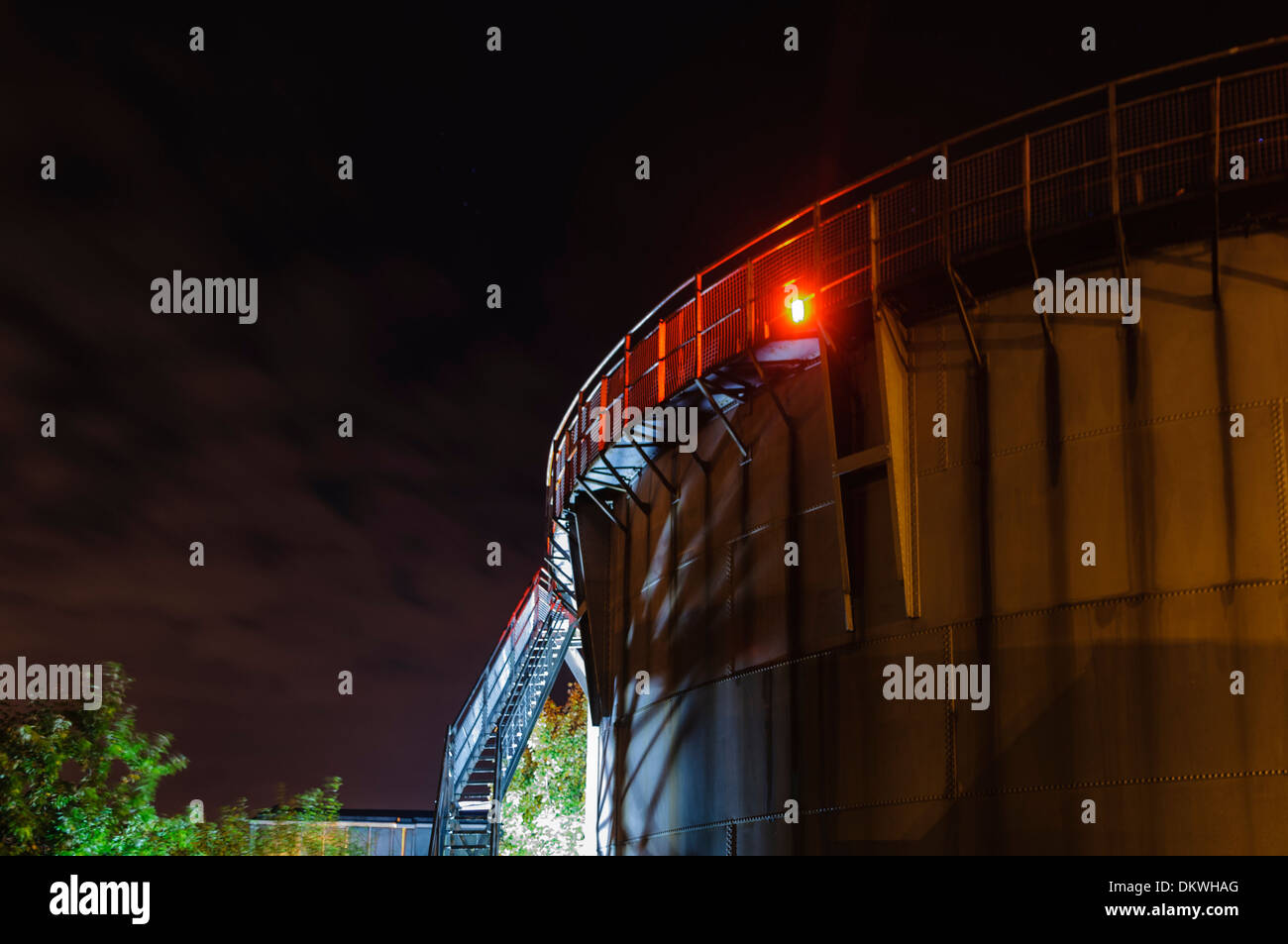A gasometer at night, used in the storage and pressure regulation of ...
