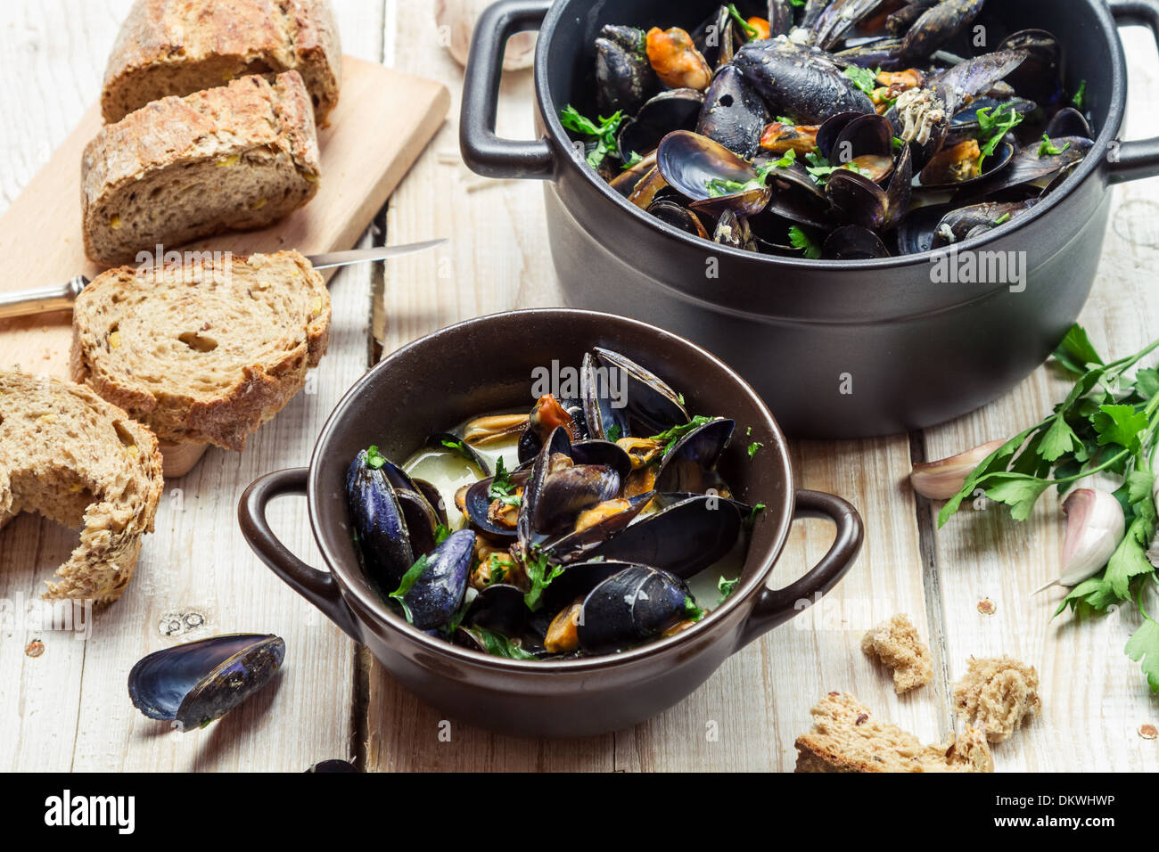 Mussels served with bread for dinner Stock Photo - Alamy