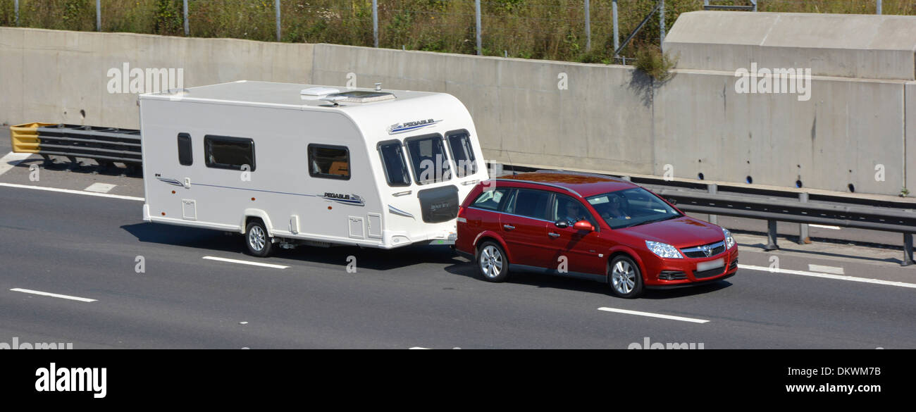 Car towing caravan on M25 motorway Essex England UK Stock Photo - Alamy