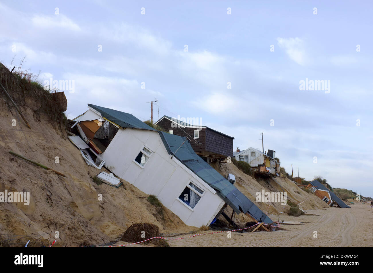 Beach homes collapse down onto beach or hang precariously over edge of ...