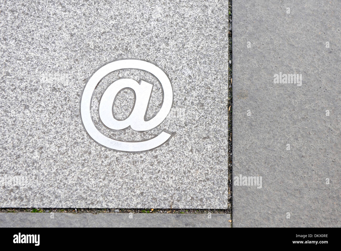At Sign on granite slab Stock Photo - Alamy