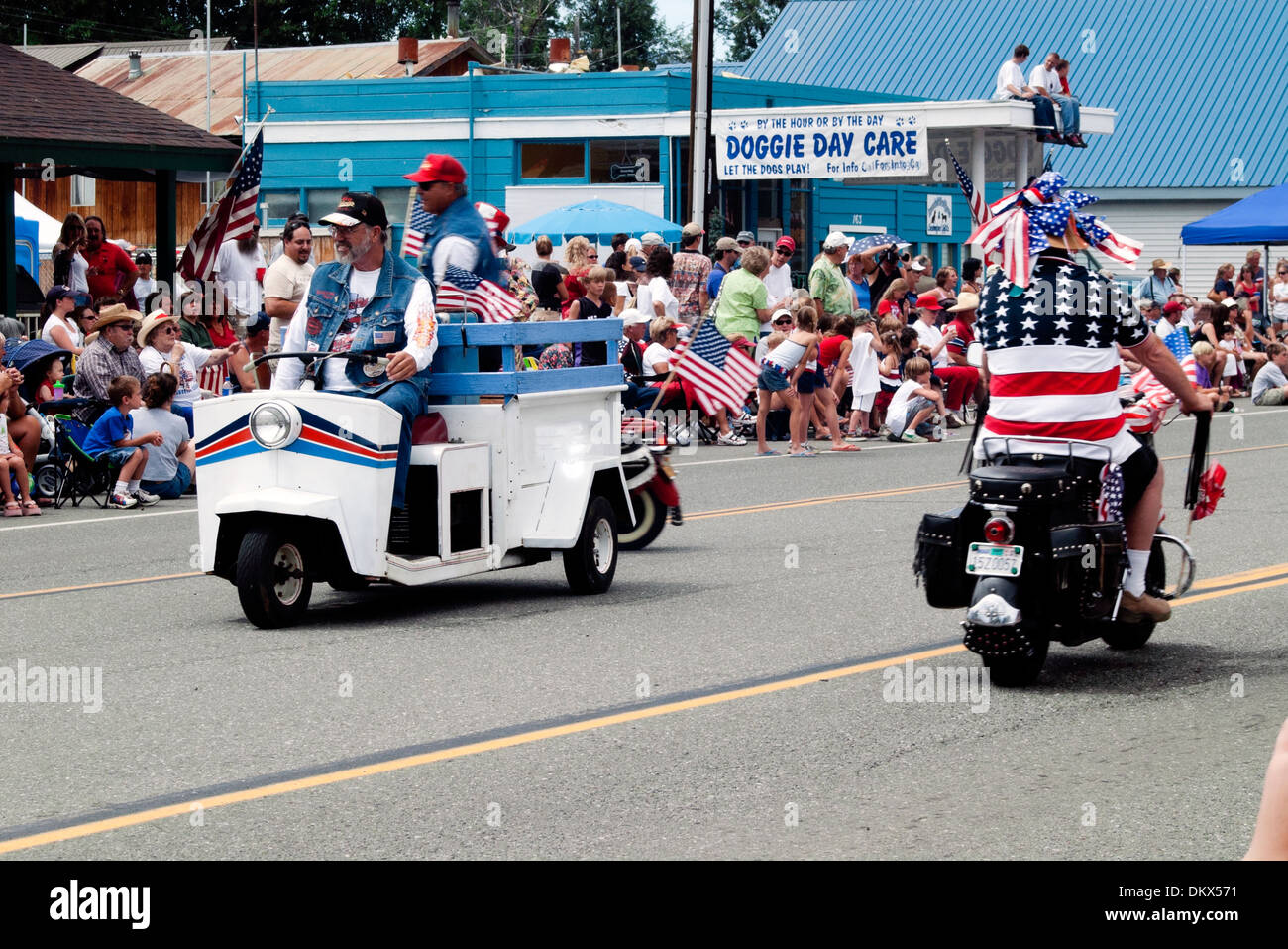 Fourth of July Parade, small town, man on scooter, men on motorcycles ...