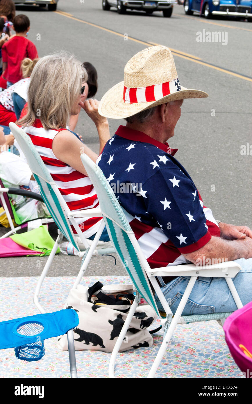 Fourth of July Parade, small town, man and woman dressed in flags sit ...
