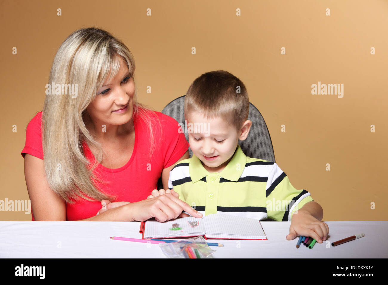 mother and son drawing together, mom helping with homework daycare ...