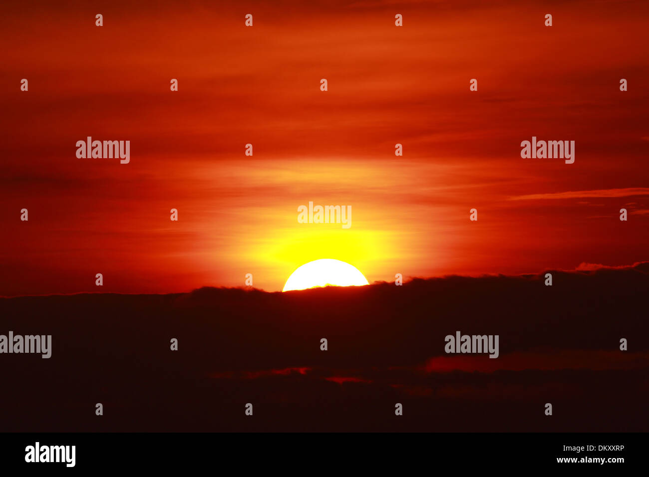 Half of the sun during sunrise on warm sky background Stock Photo - Alamy