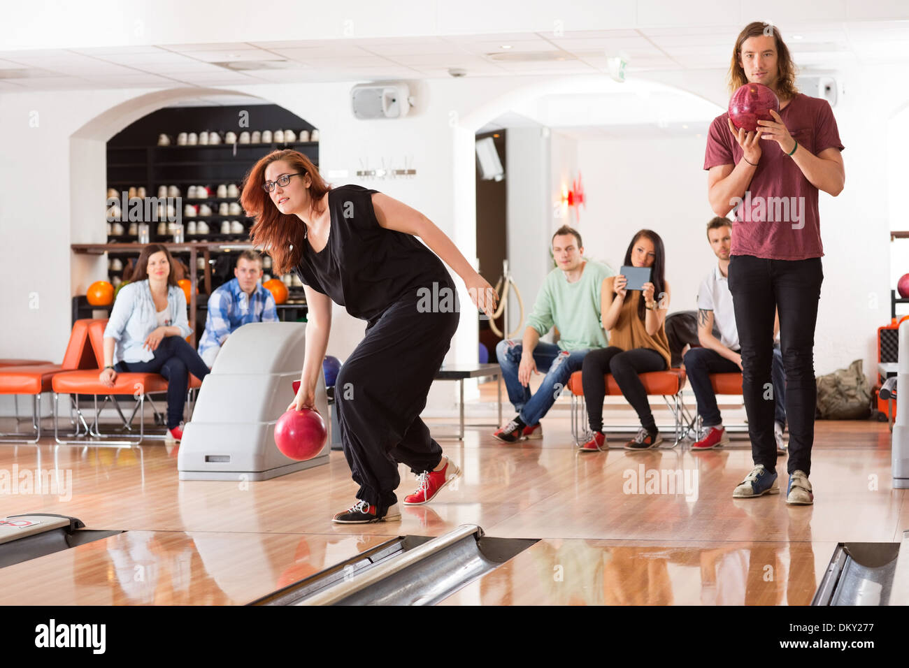 Friends Bowling in Club Stock Photo - Alamy