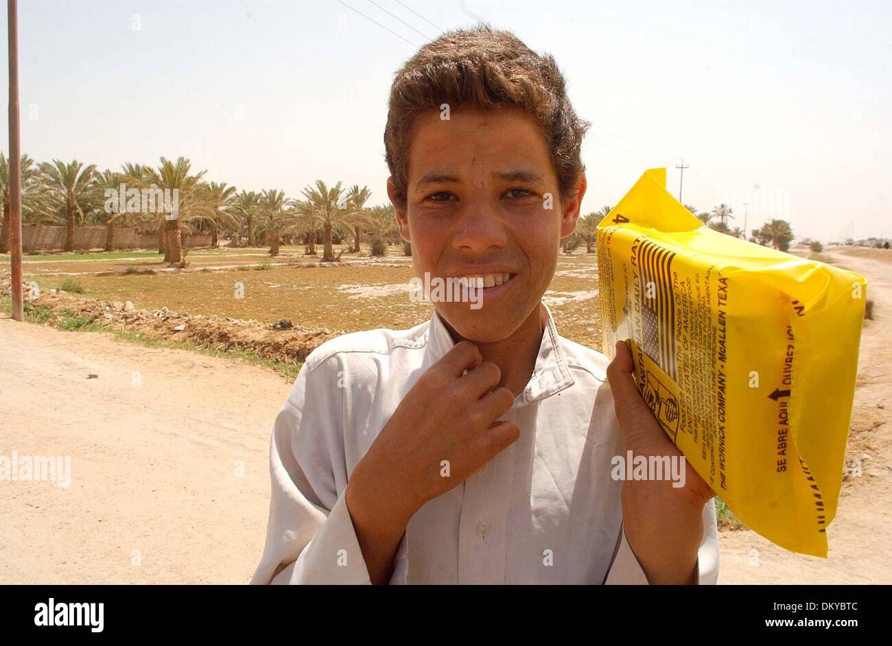 Nov. 23, 2002 - An Iraqi boy shows off the Humanitarian Daily Ration he ...