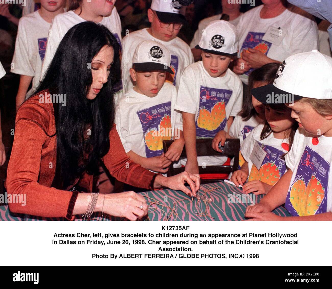 June 26, 1998 - Dallas, TX, USA - Actress Cher, left, gives bracelets ...