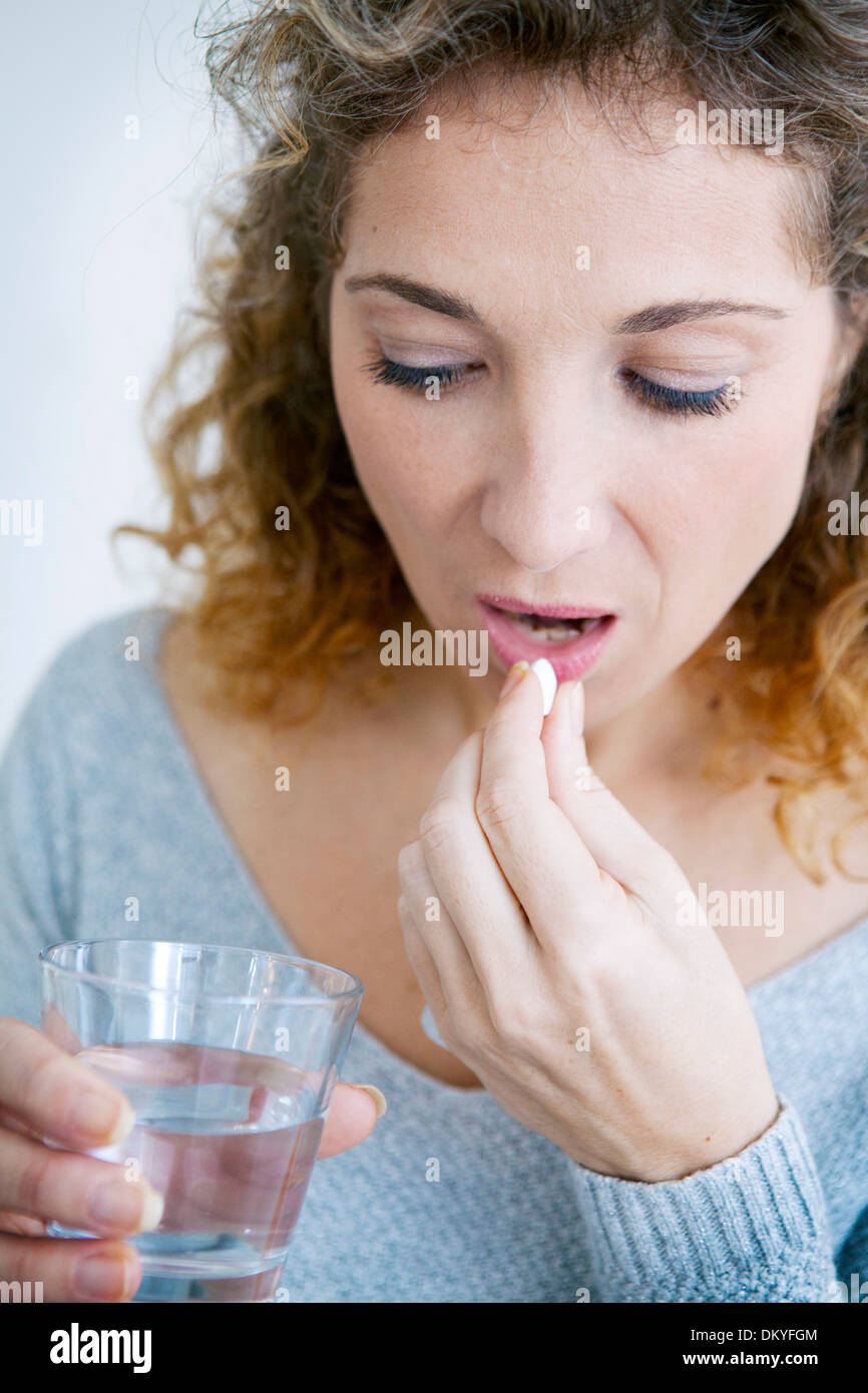 WOMAN TAKING MEDICATION Stock Photo - Alamy