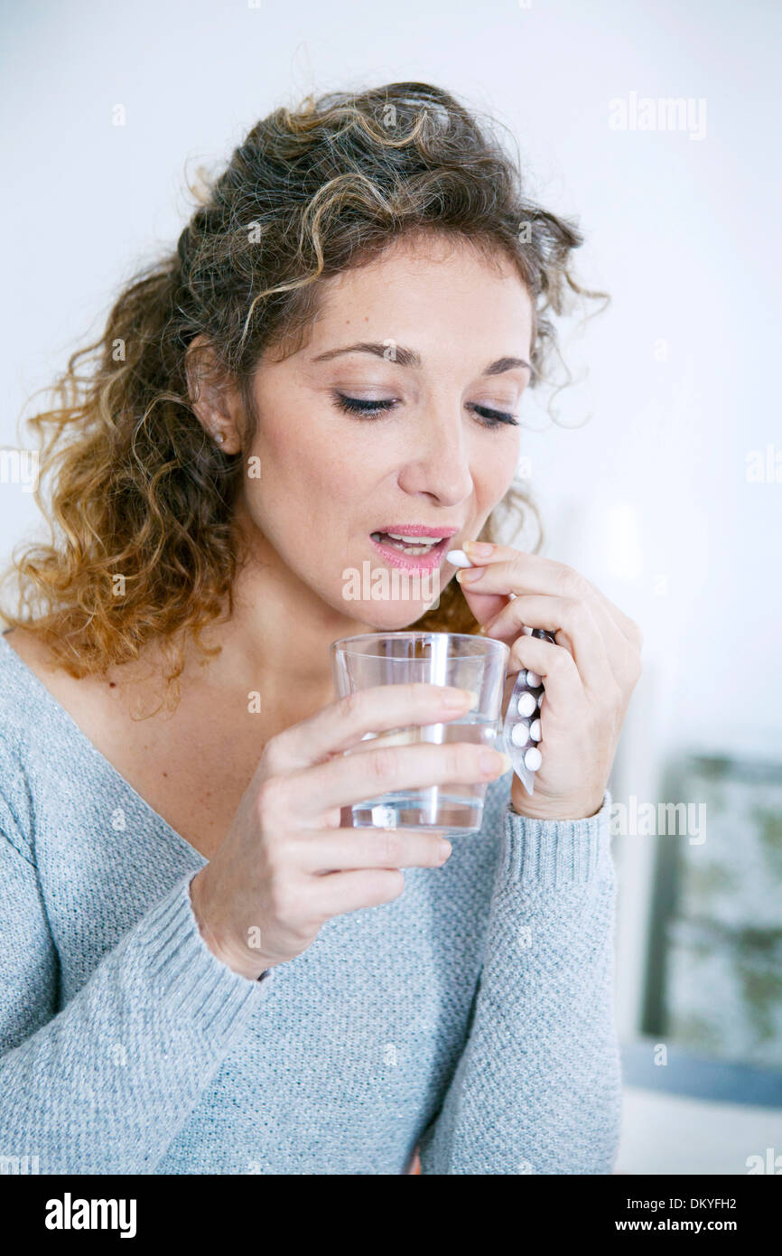 WOMAN TAKING MEDICATION Stock Photo - Alamy
