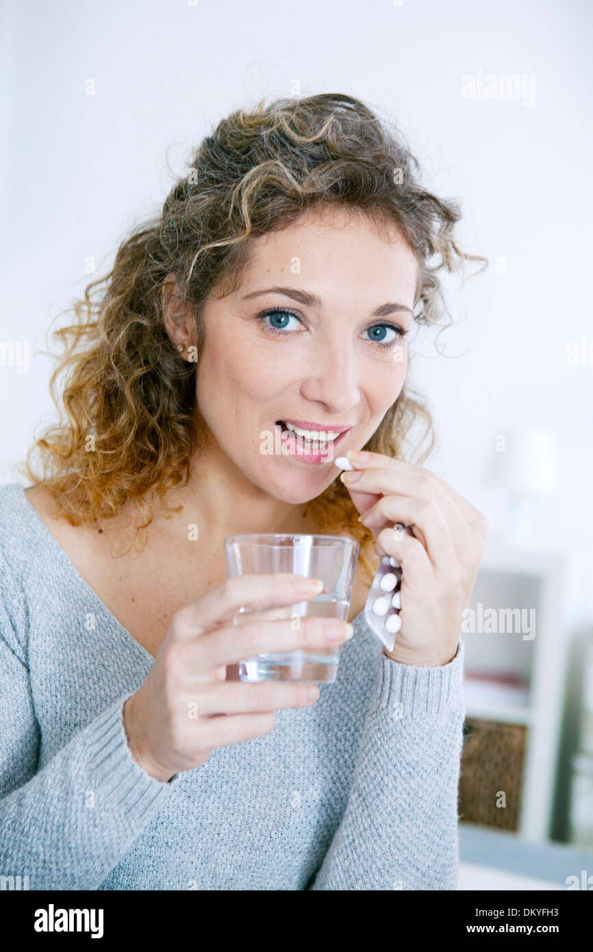 WOMAN TAKING MEDICATION Stock Photo - Alamy