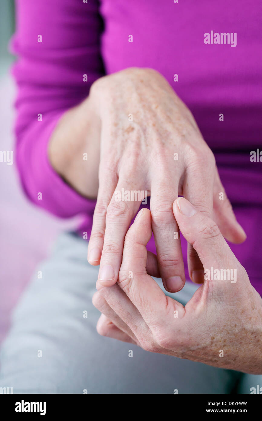 ELDERLY PERSON WITH PAINFUL HAND Stock Photo - Alamy