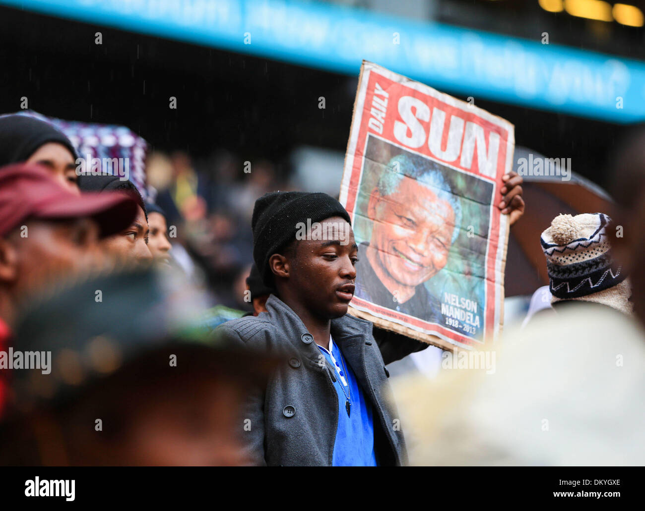 Johannesburg, South Africa. 10th Dec, 2013. People hold a poster of ...