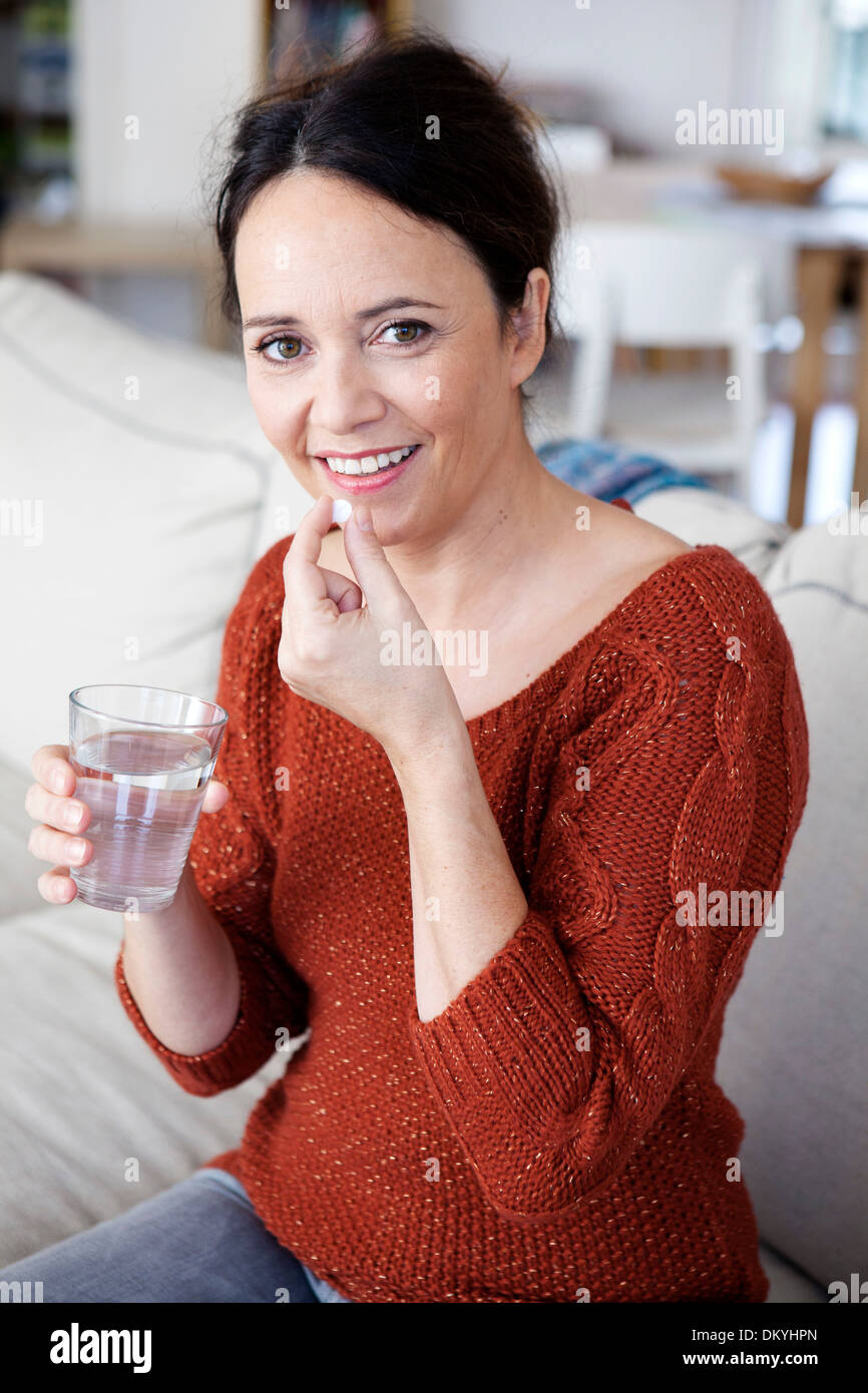 Woman taking tablet hi-res stock photography and images - Alamy