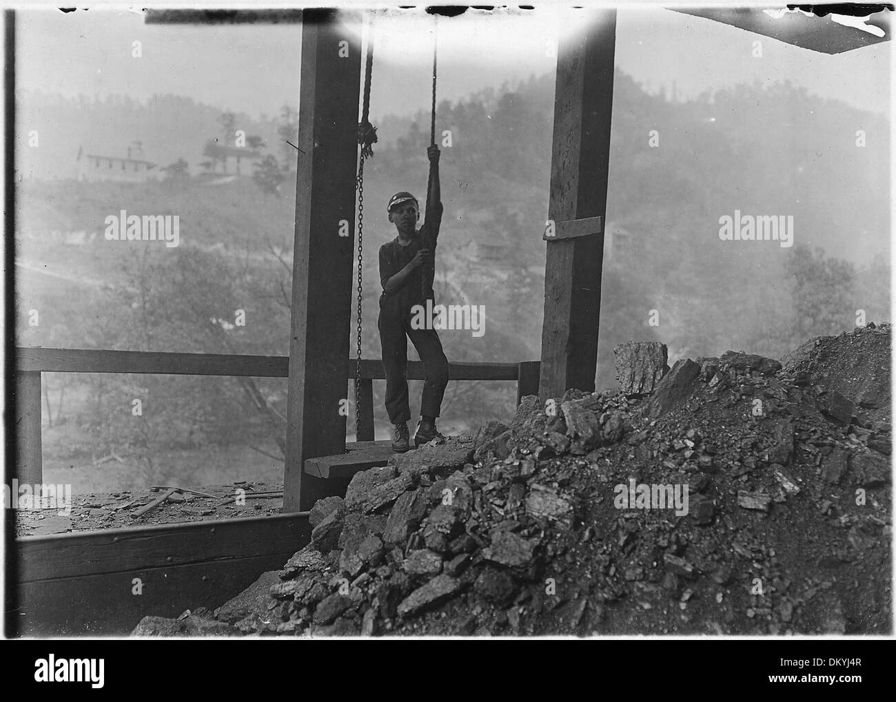 A young boy is seen operating the 'trip rope' at a coal tipple at Welch ...