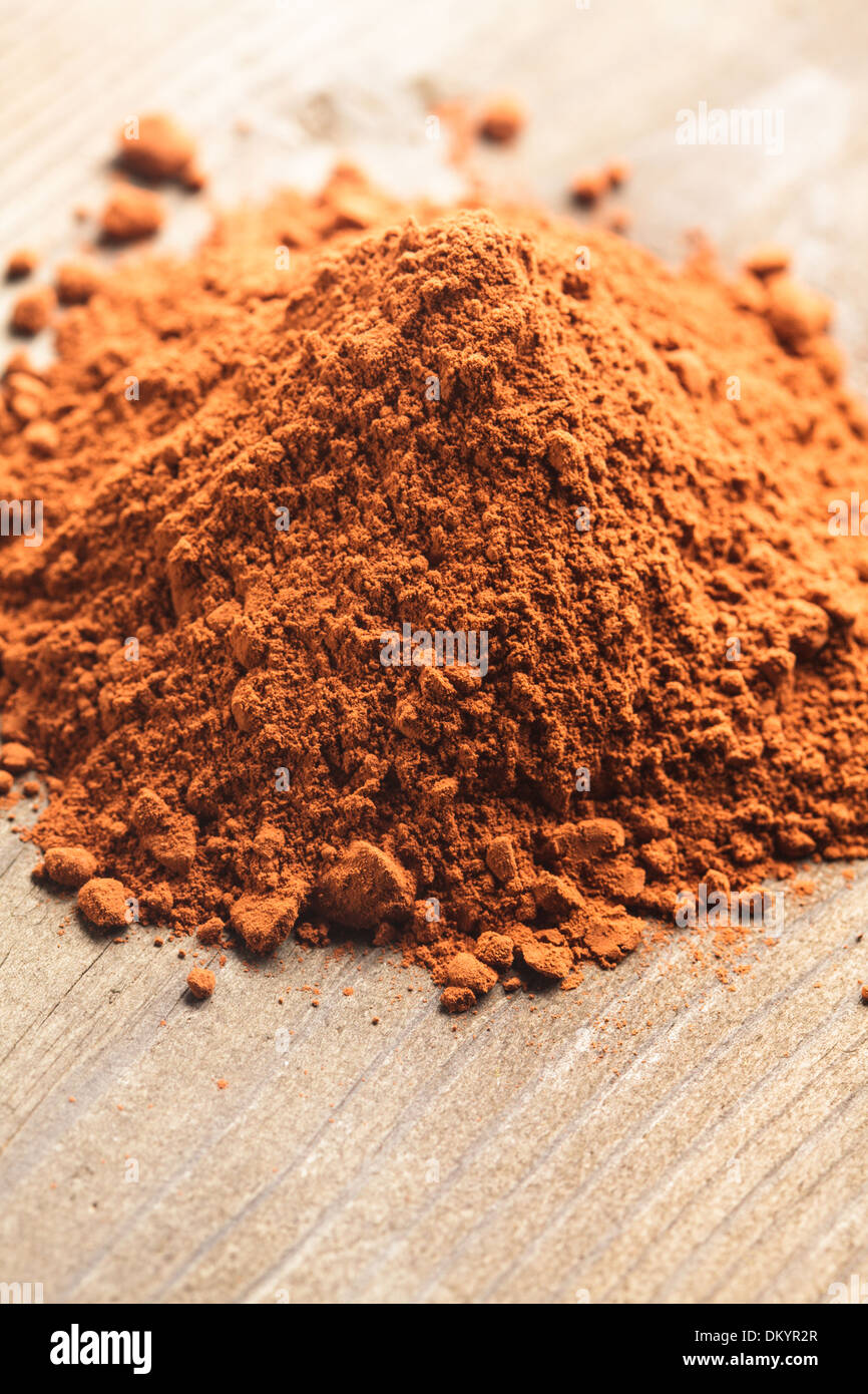 chocolate powder heap over wooden background Stock Photo - Alamy