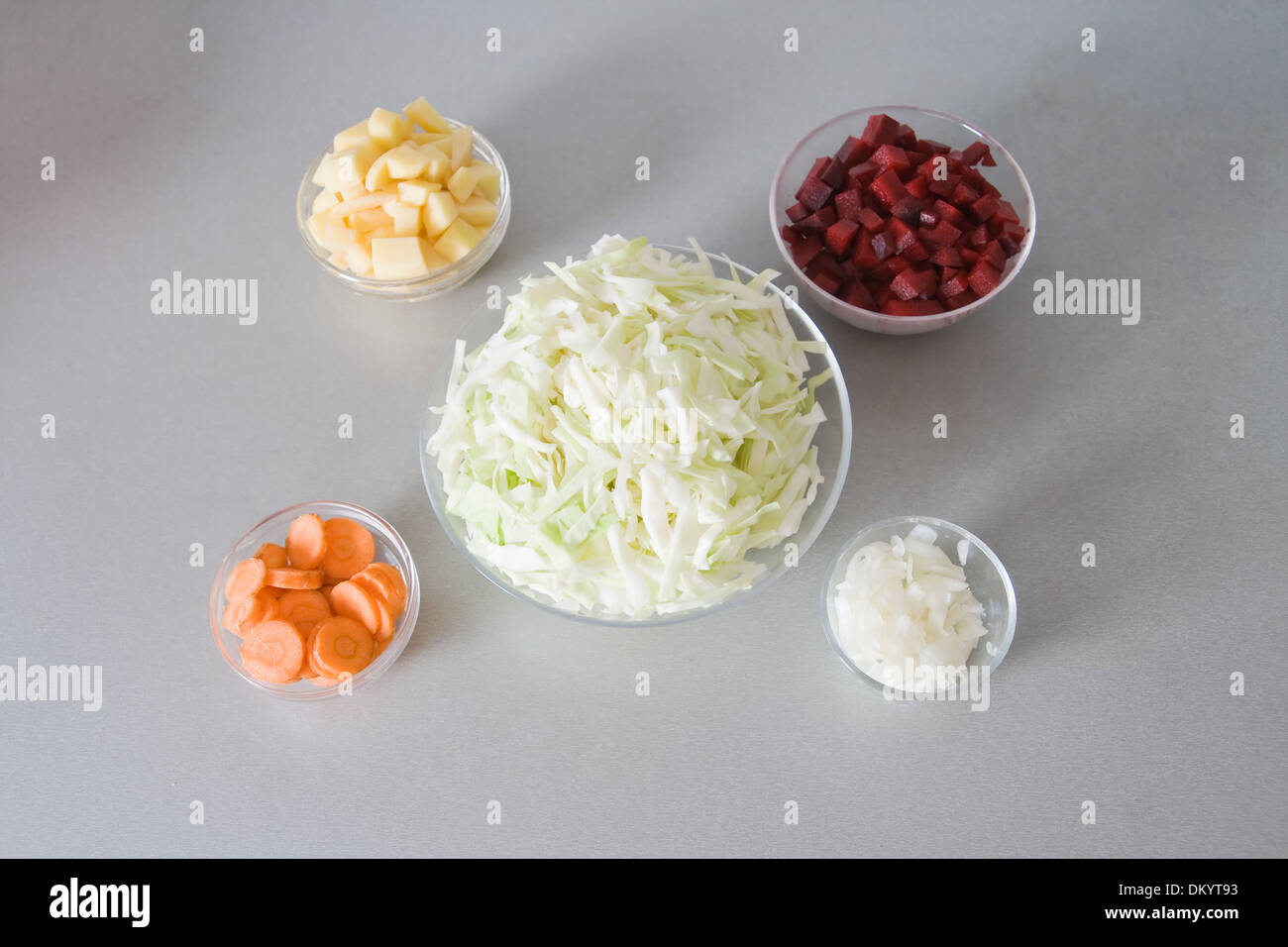Five bowls with chopped vegetables, ingredients for vegetable soup ...