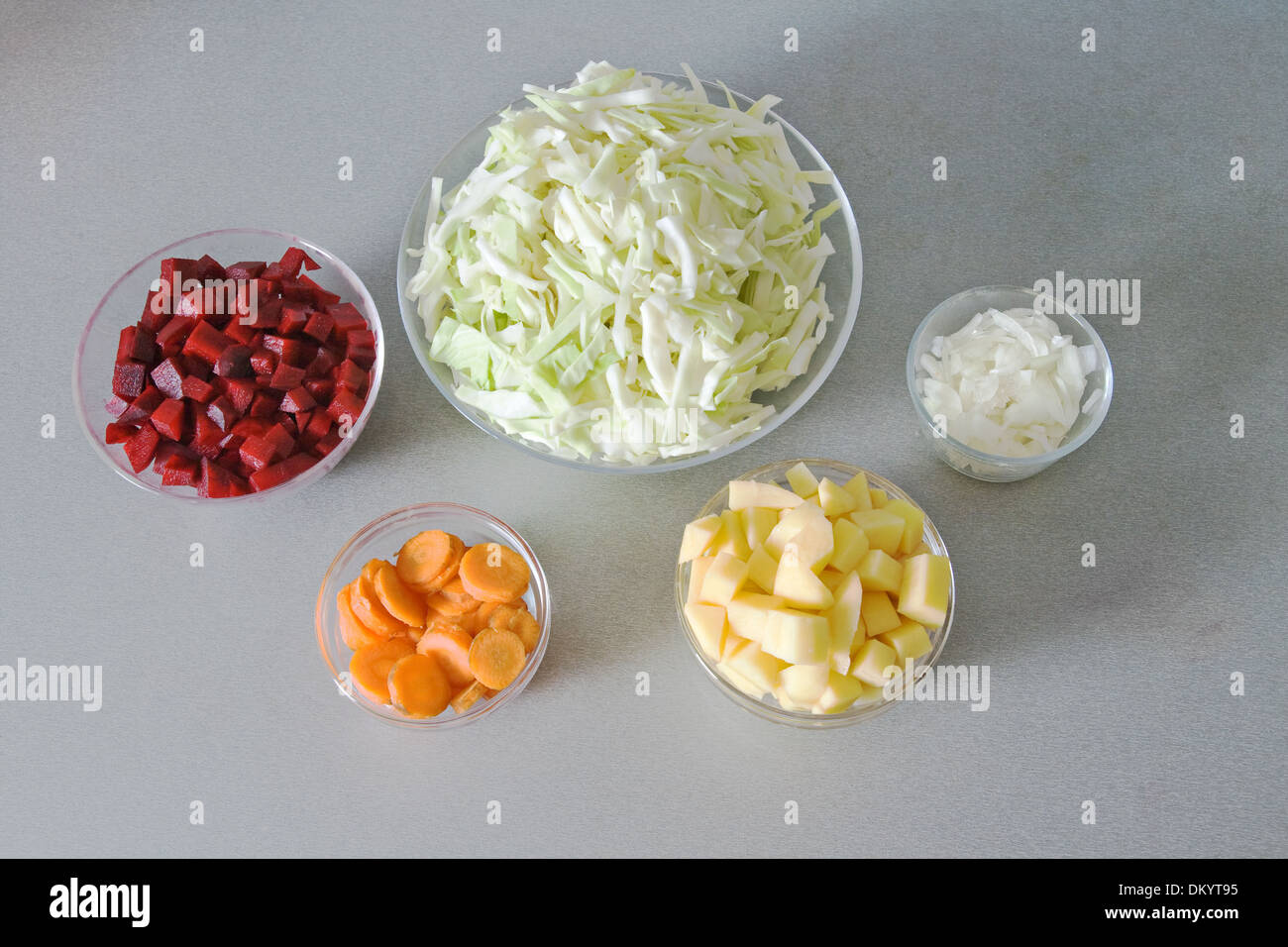 Five bowls with chopped vegetables, ingredients for vegetable soup ...