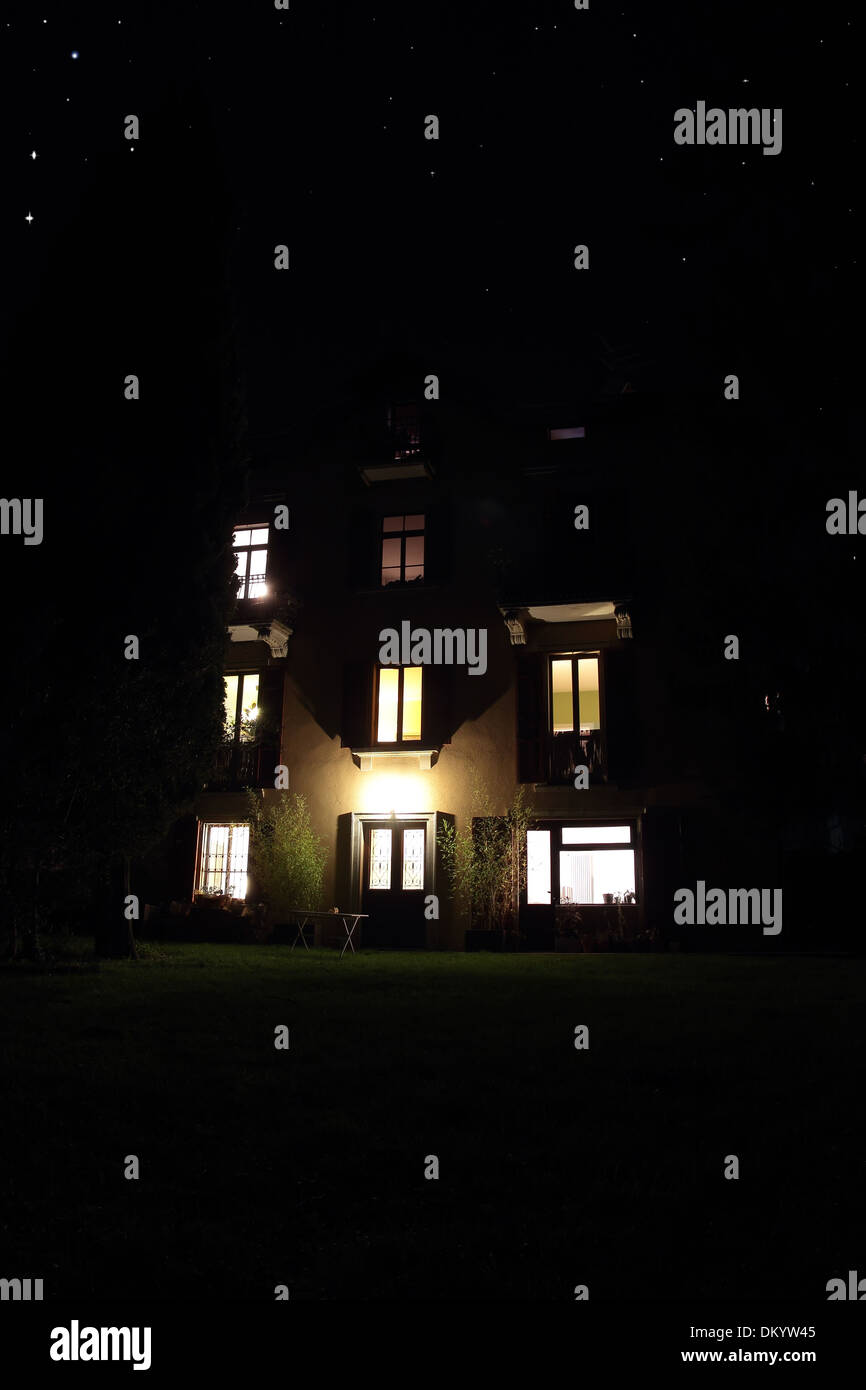 illuminated house under a starry night Stock Photo - Alamy