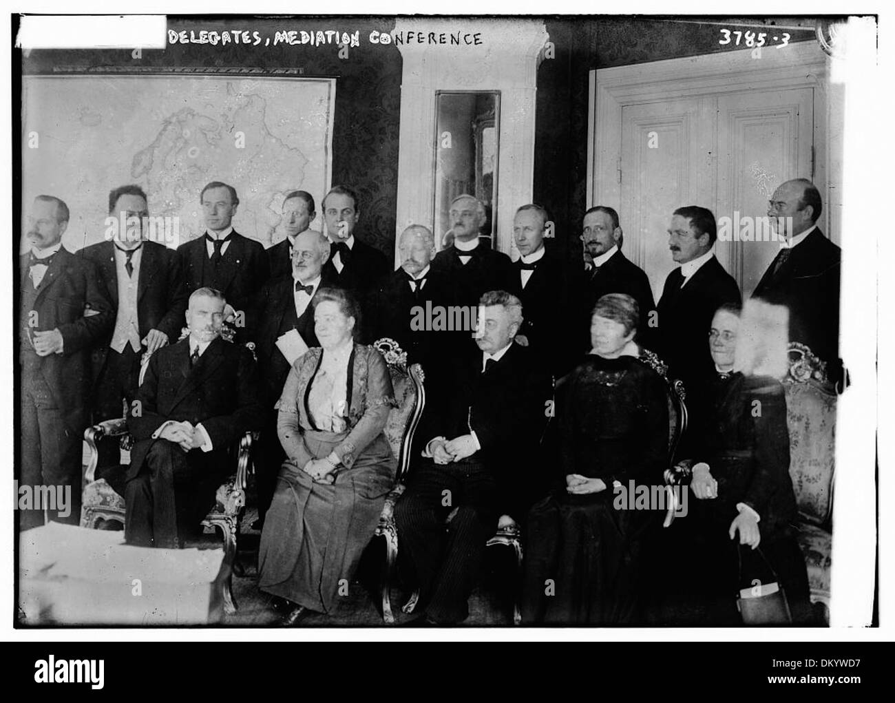 This historical photograph depicts delegates at a mediation conference ...