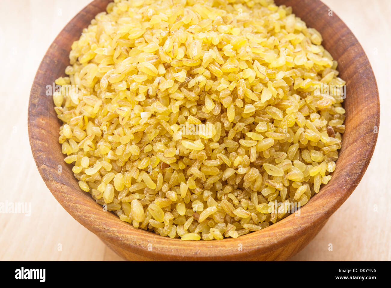 Raw bulgur in a wooden bowl on the table Stock Photo - Alamy