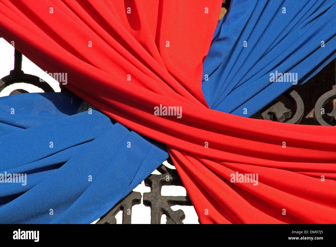 A blue and red cloth sash draped over a steel railing in Quito, Ecuador ...