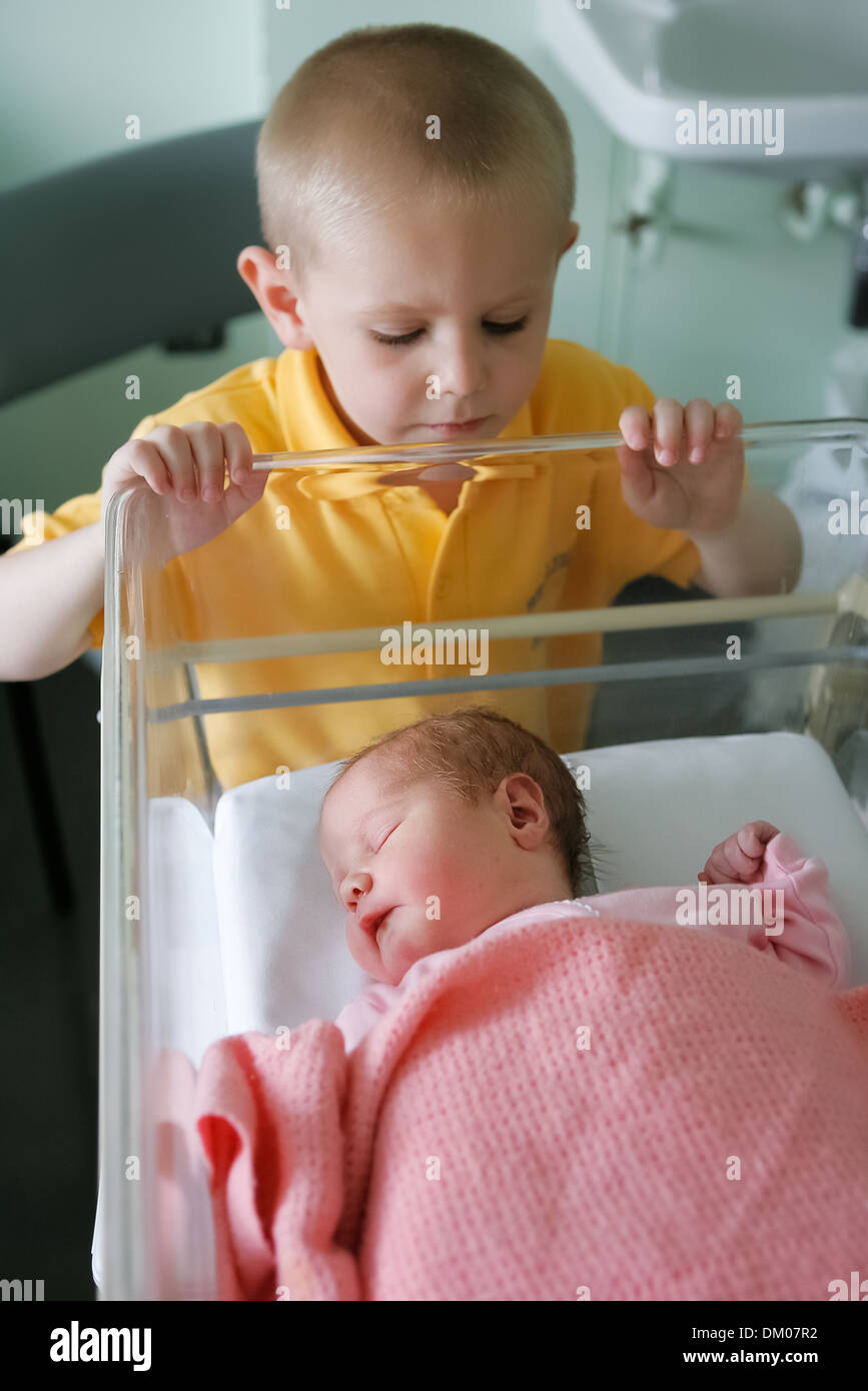A young boy meets his newborn baby sister for the first time in ...
