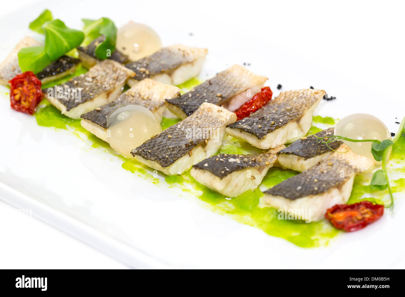 Baked black cod fish on a white background Stock Photo - Alamy