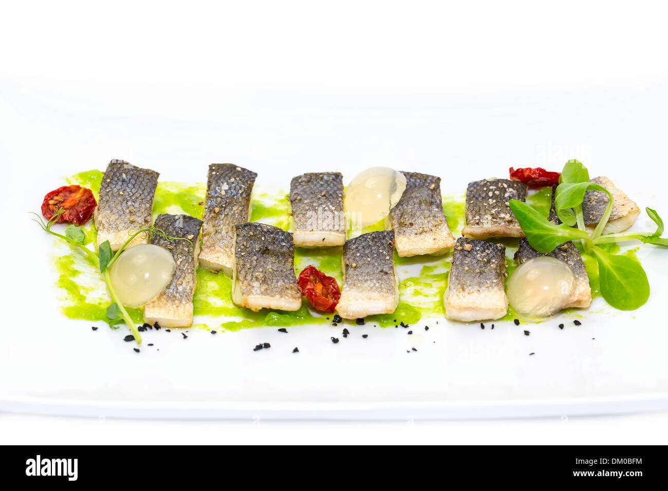 Baked black cod fish on a white background Stock Photo - Alamy