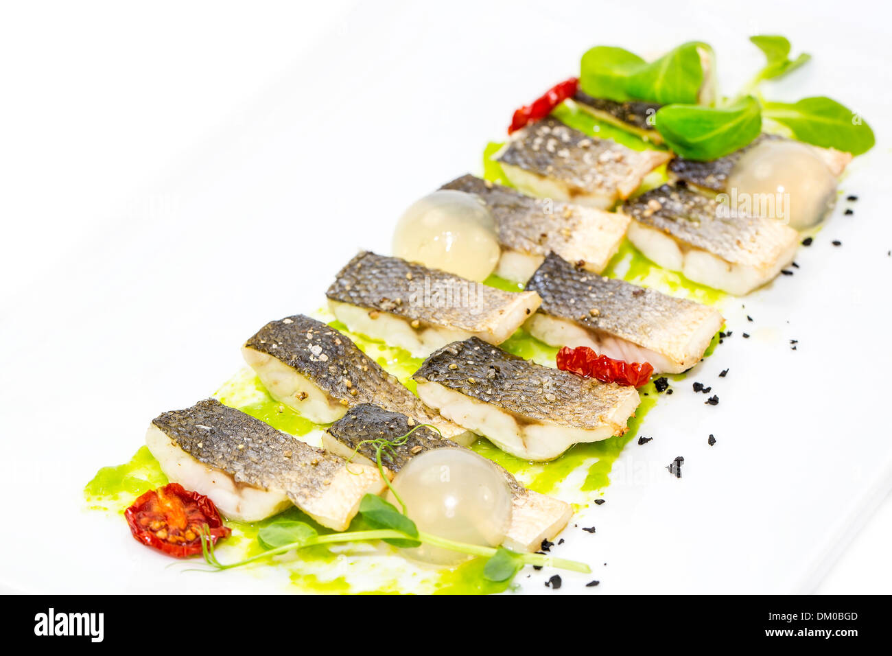 Baked black cod fish on a white background Stock Photo - Alamy