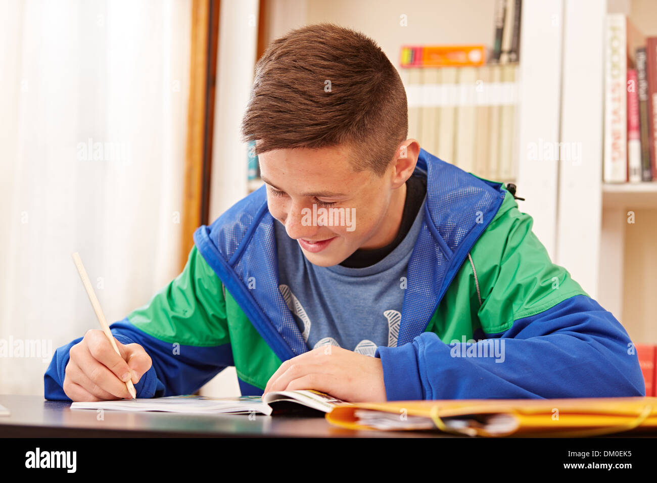 Male teenager concentrated doing homework in a desk Stock Photo - Alamy