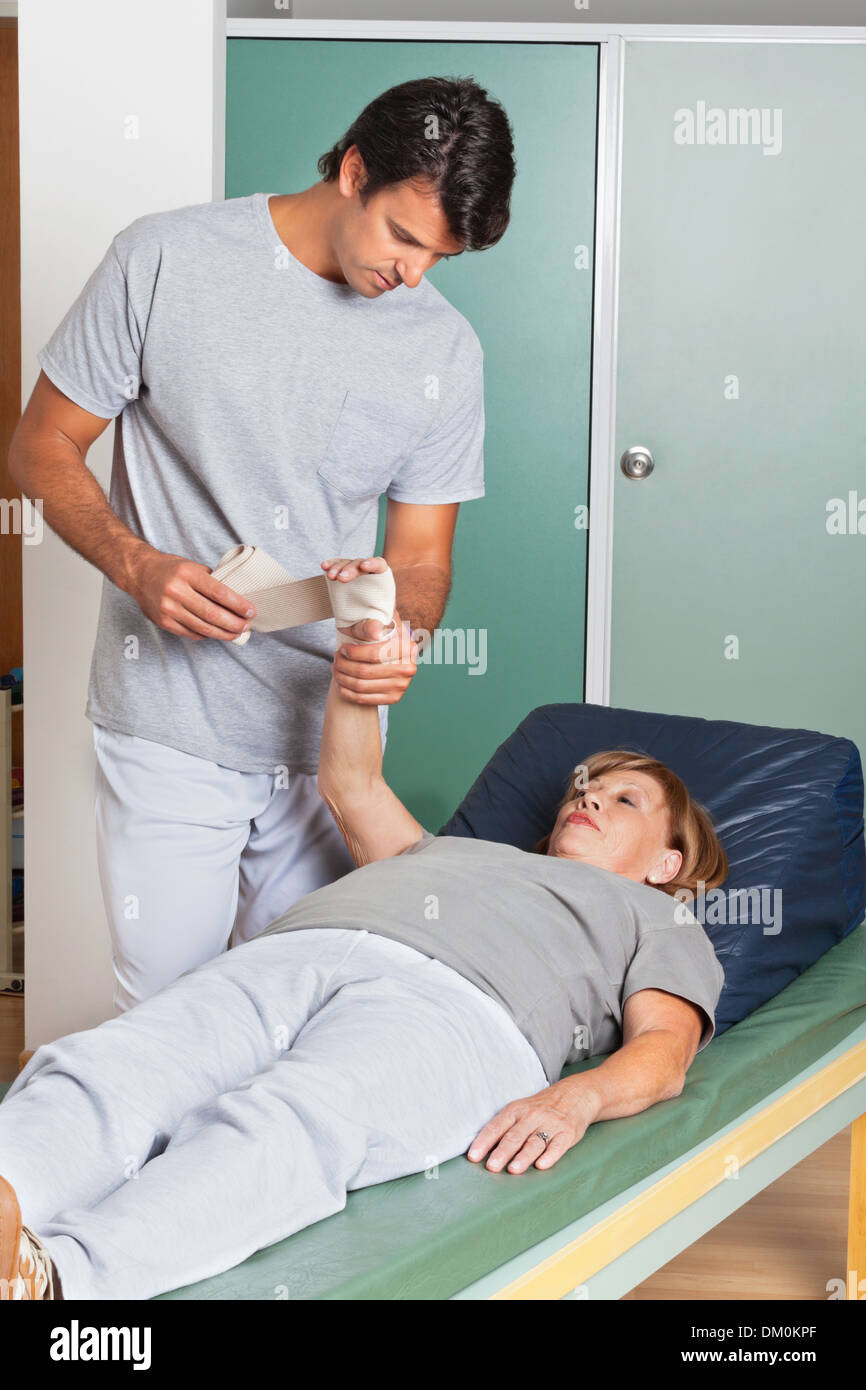 Doctor Applying Bandage On Patient's Hand Stock Photo - Alamy