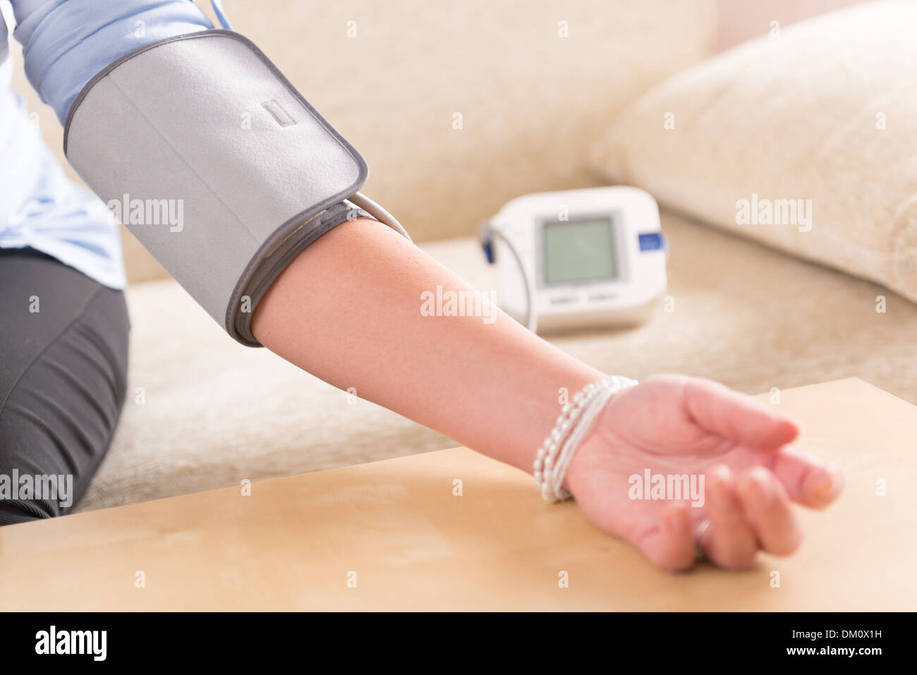 Women's hand with blood pressure monitor cuff Stock Photo - Alamy