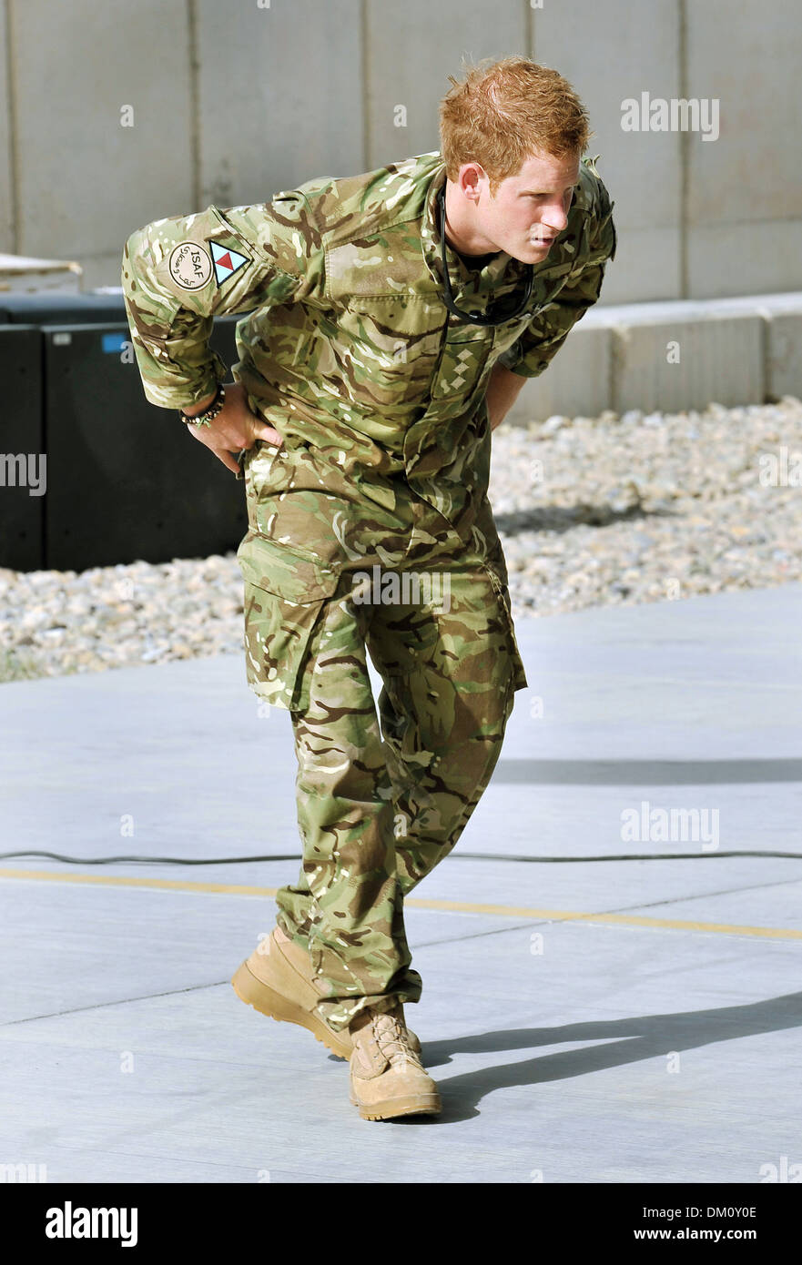 Prince Harry examines 30mm cann of an Apache helicopter at Camp Bastion ...