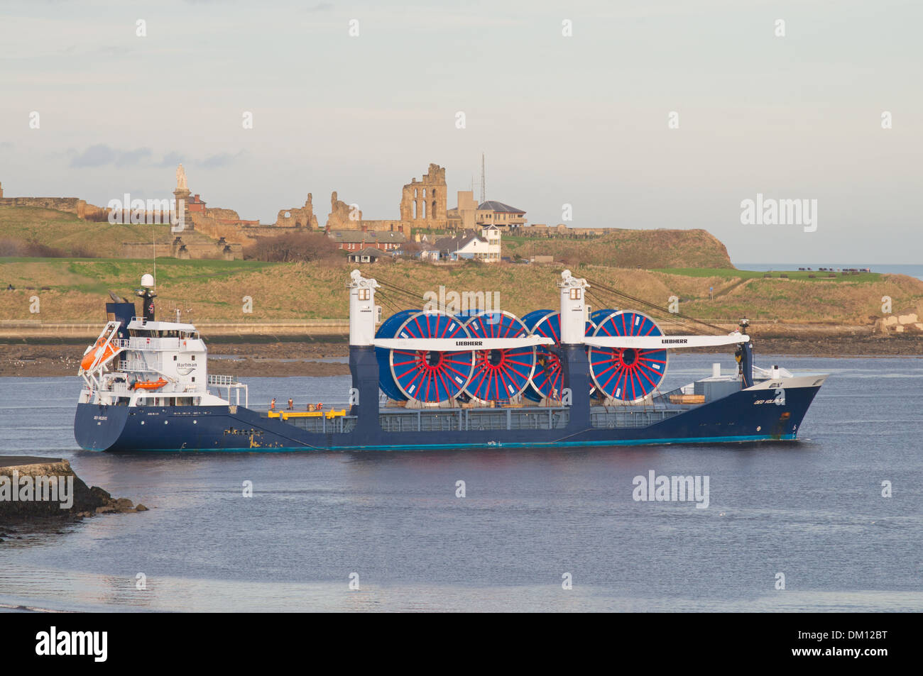 Cargo vessel Deo Volente leaving the river Tyne with cable or hose ...