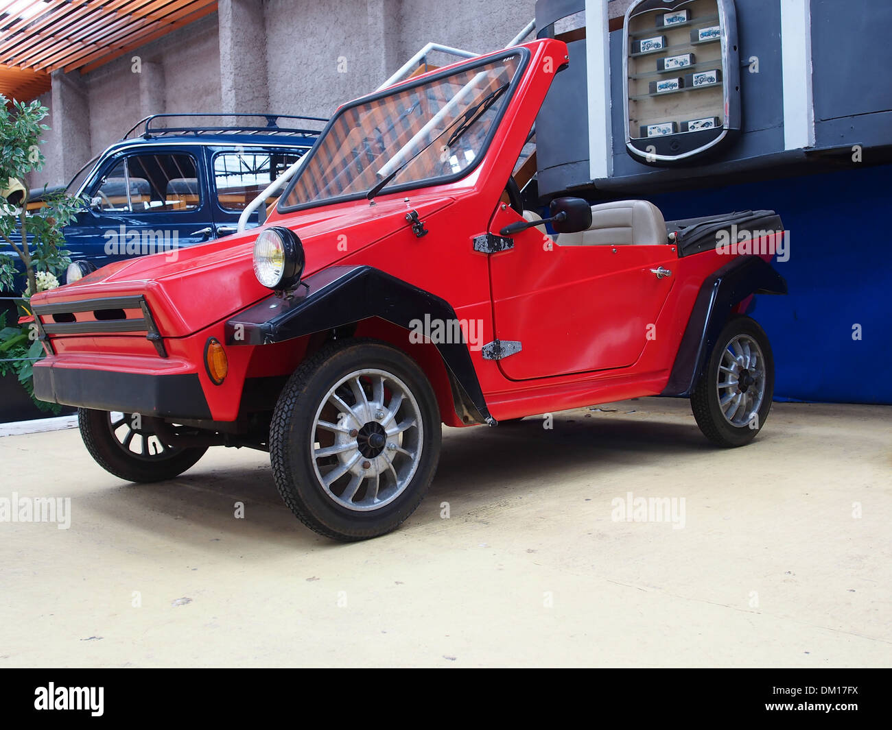 The red Tomcar is an all-terrain utility vehicle designed for off-road ...