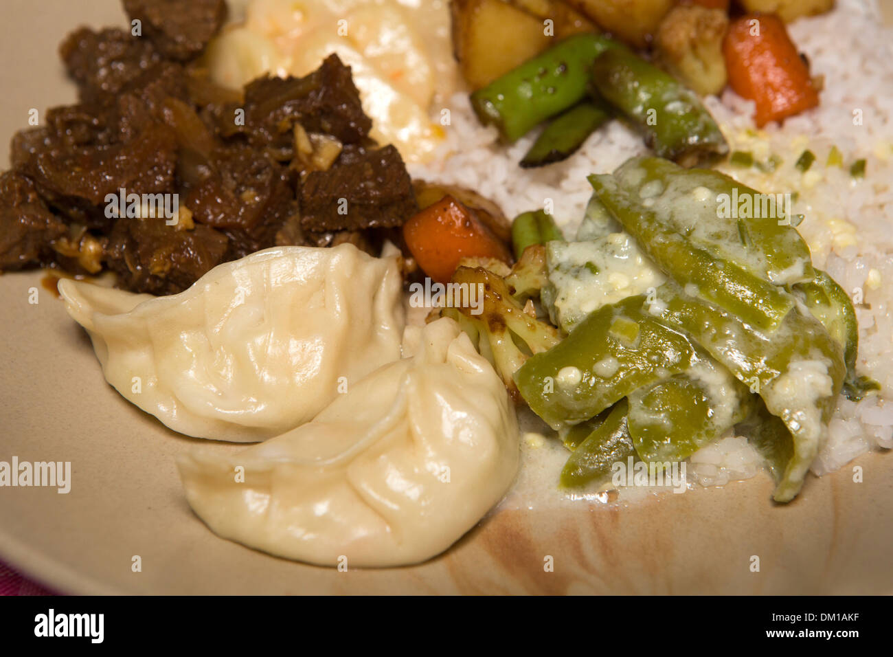 Bhutan, Bhutanese food, plate of ema datse, steamed momos, pork and ...